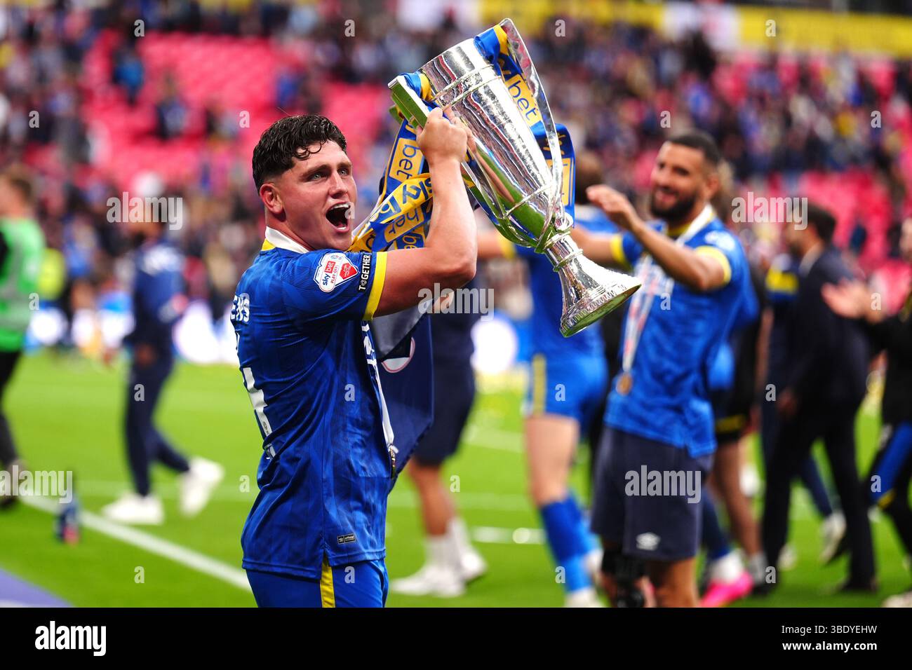AFC Wimbledon's Matty Stevens celebrates with the trophy following ...