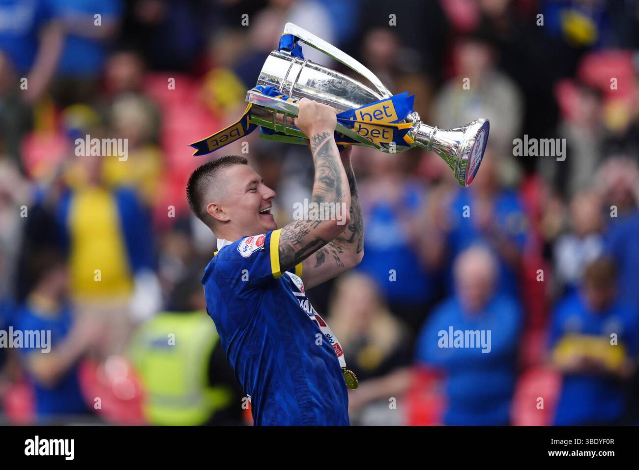 AFC Wimbledon's James Tilley with the trophy after the Sky Bet League ...