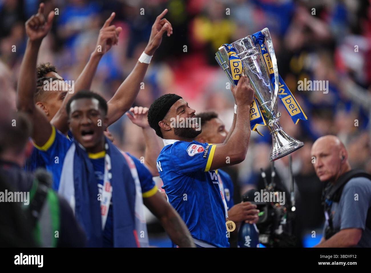 AFC Wimbledon's Ryan Johnson with the trophy after the Sky Bet League ...