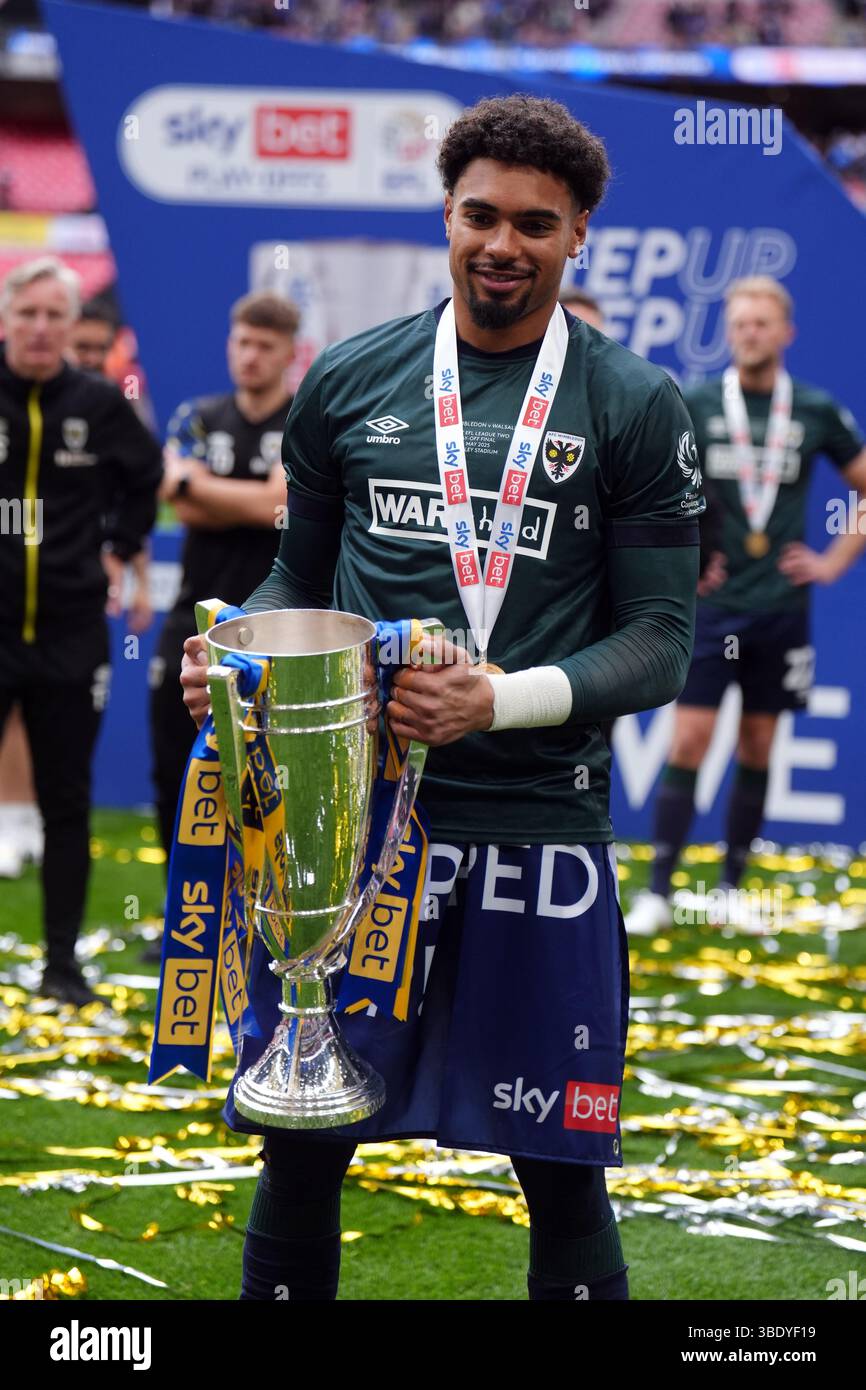 AFC Wimbledon goalkeeper Owen Goodman with the trophy after the Sky Bet ...