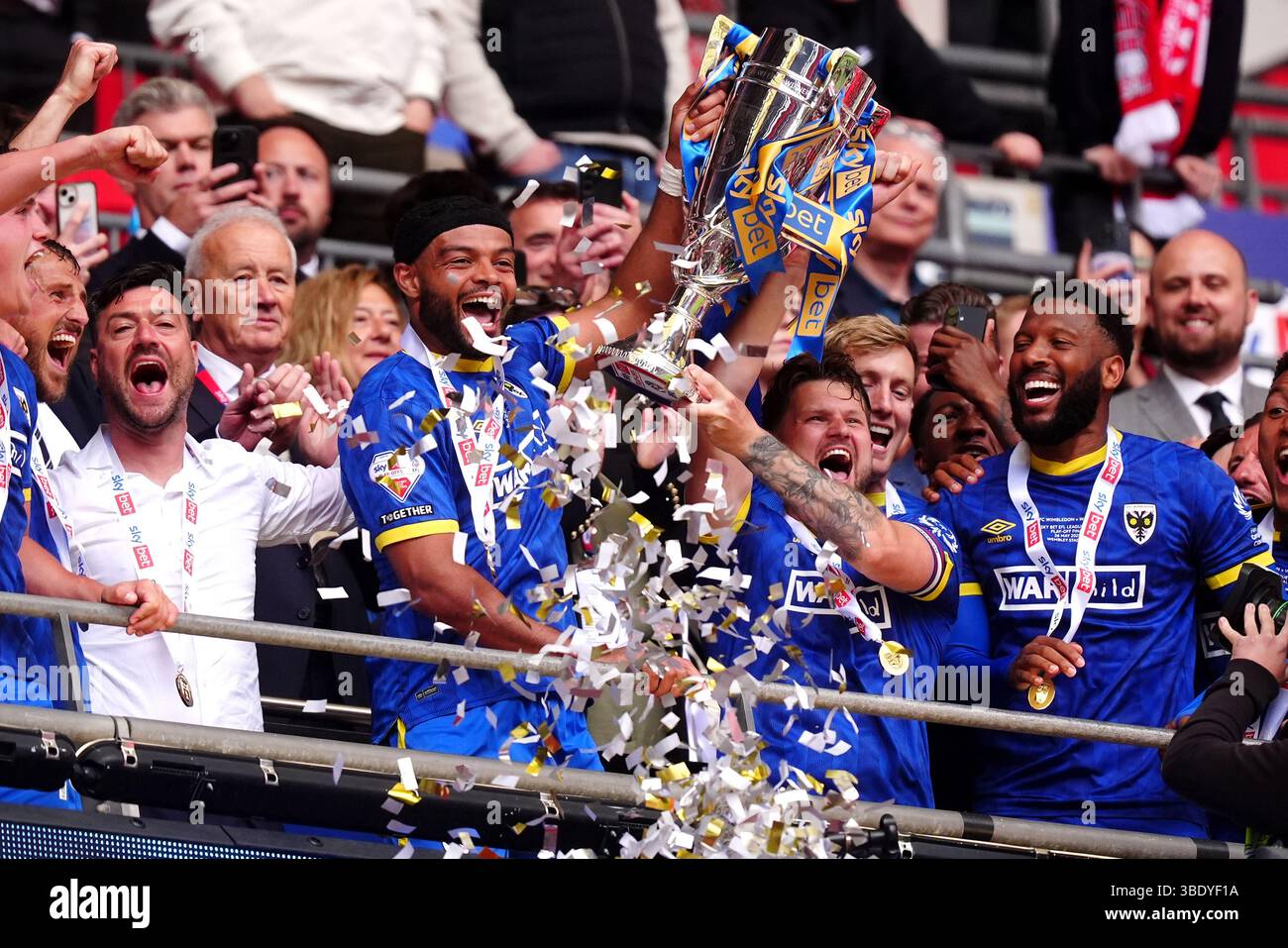 AFC Wimbledon's Ryan Johnson and Jack Reeves lift the trophy with team ...