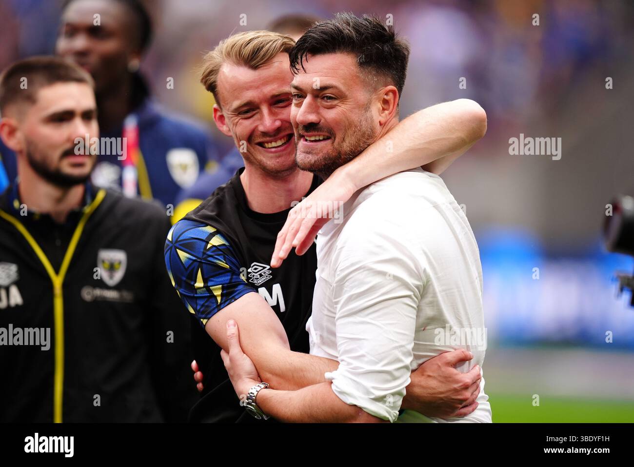 AFC Wimbledon manager Johnnie Jackson (right) celebrates victory with ...