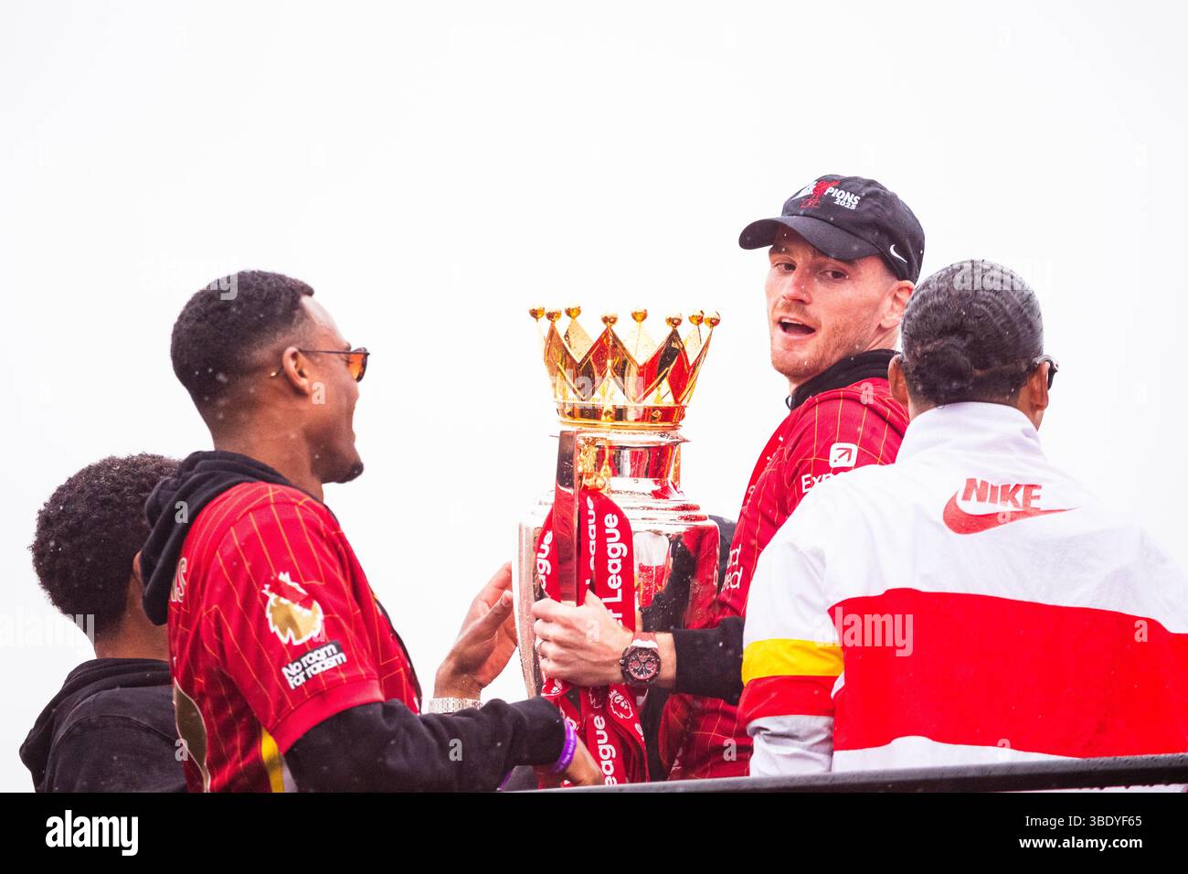 Andrew Robertson passing the league trophy to Ryan Gravenberch during ...