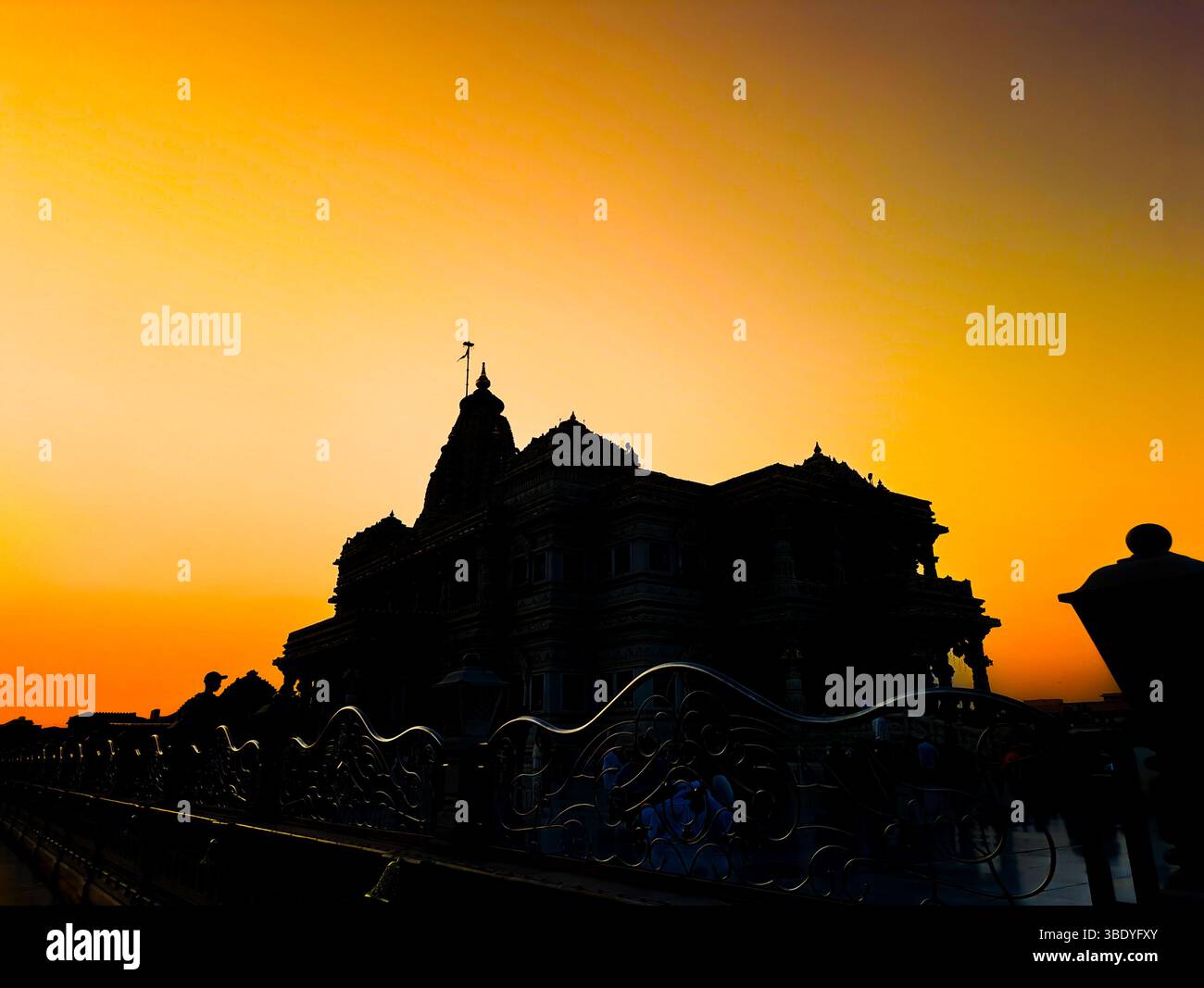 backlit ancient hindu temple architecture with orange bright sunset ...