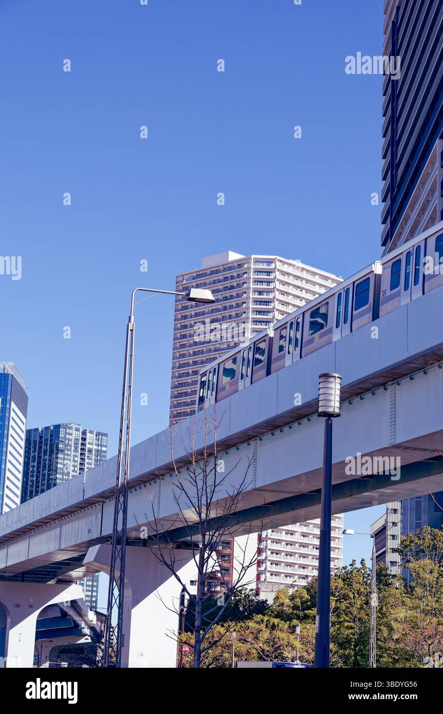 Yurikamome Line glides through the Tokyo skyline on a clear winter ...
