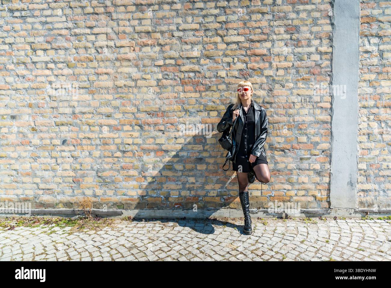 Punk style fashion girl in black edgy outfit with leather jacket and ...