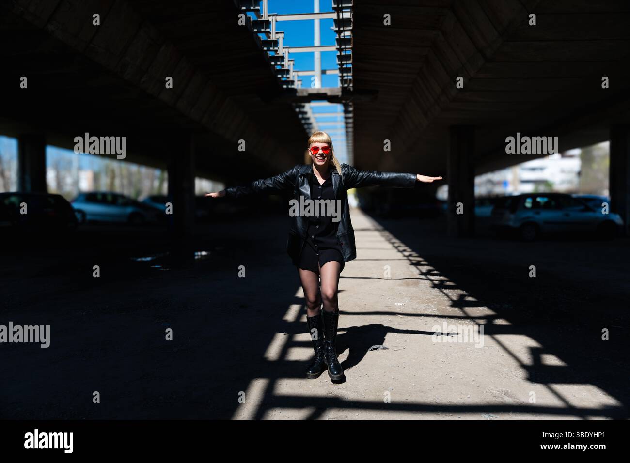 Punk style fashion girl in black edgy outfit with leather jacket and ...