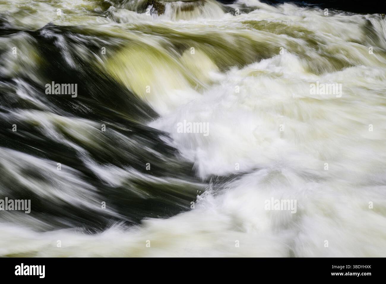 Turbulent mountain river creating white water chaos during spring ...