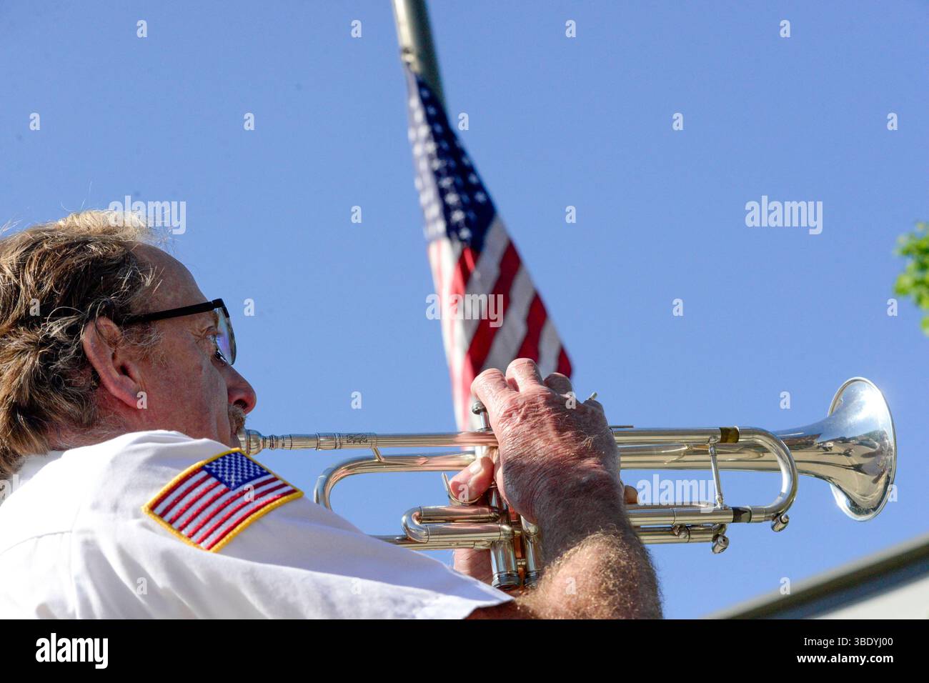 Arnie Rose plays "Taps" on the bugle as members of the American Legion ...