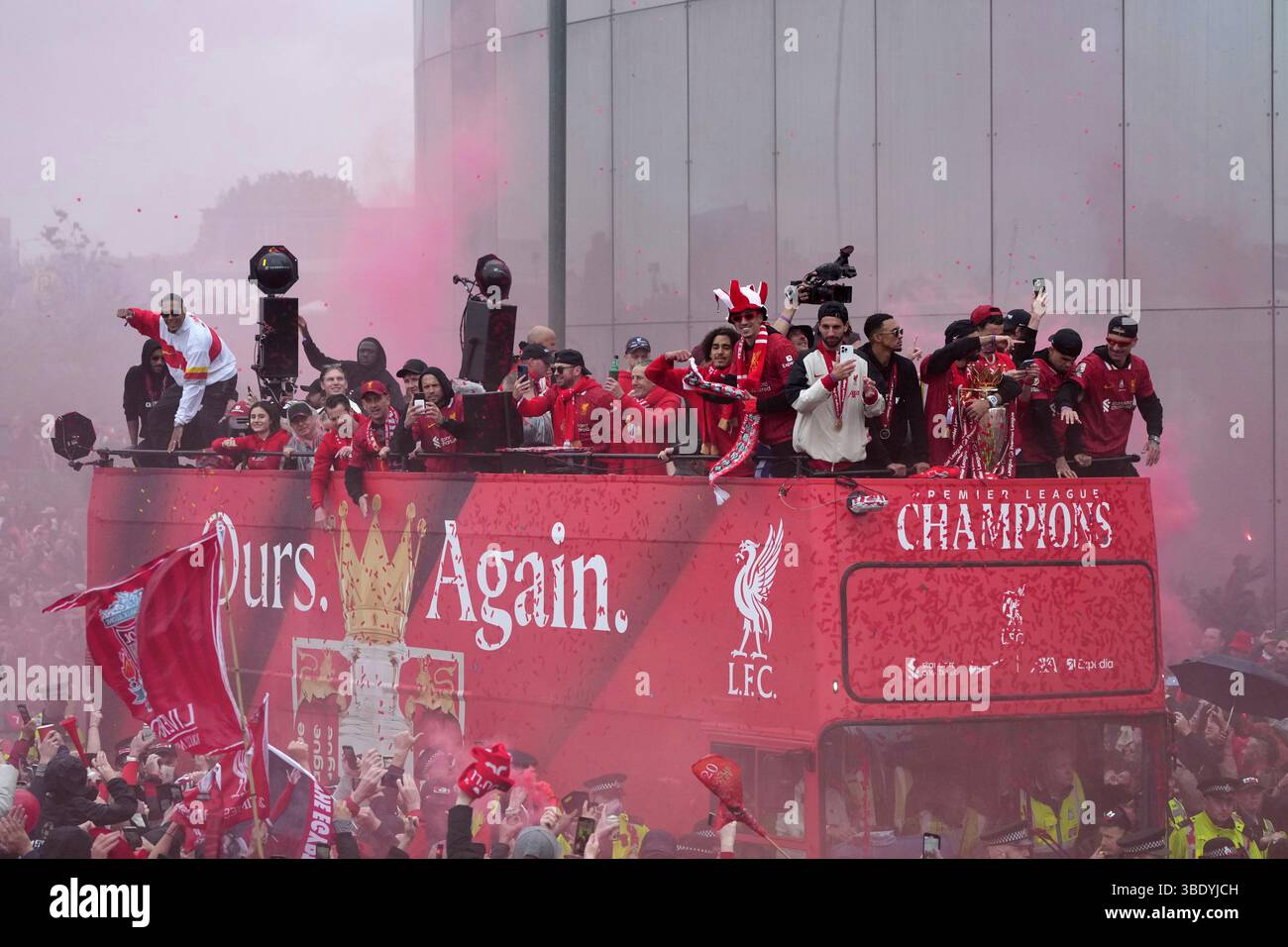 Liverpool players celebrate with the trophy on an open-top bus during ...