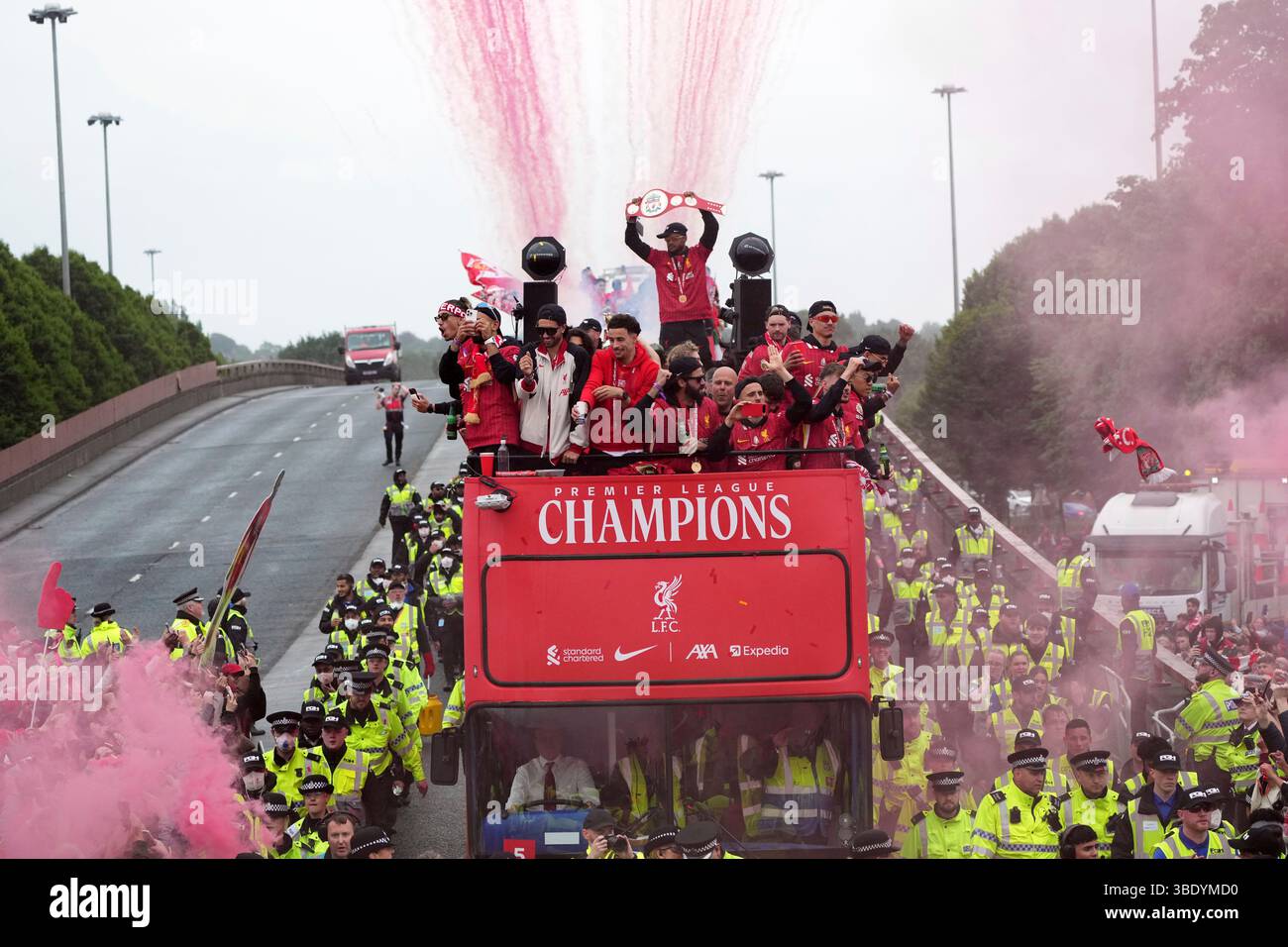 Liverpool players celebrate with the trophy on an open-top bus during the Liverpool FC Premier ...