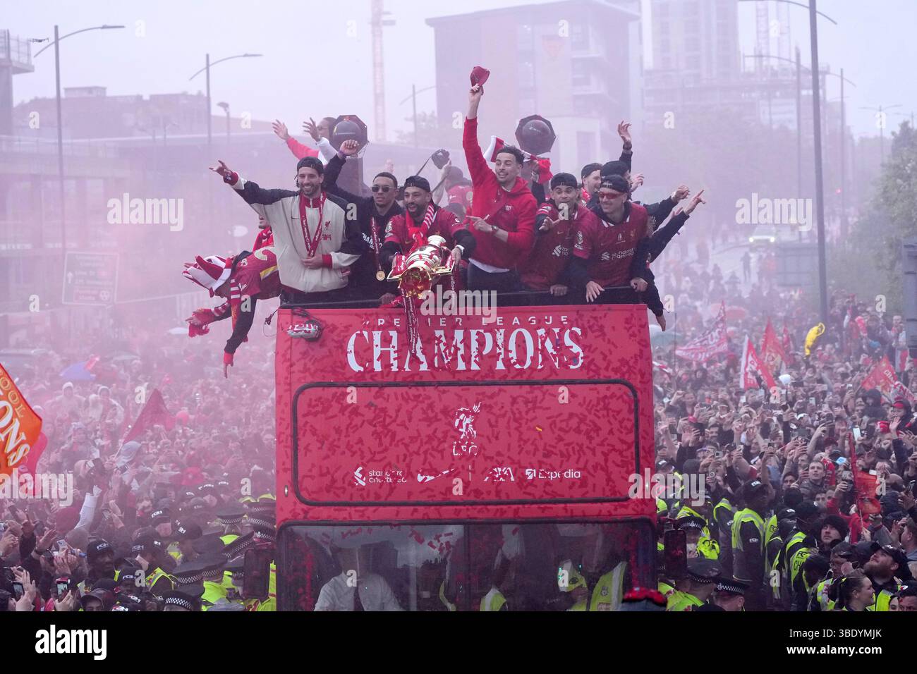 Liverpool players celebrate with the trophy on an open-top bus during ...