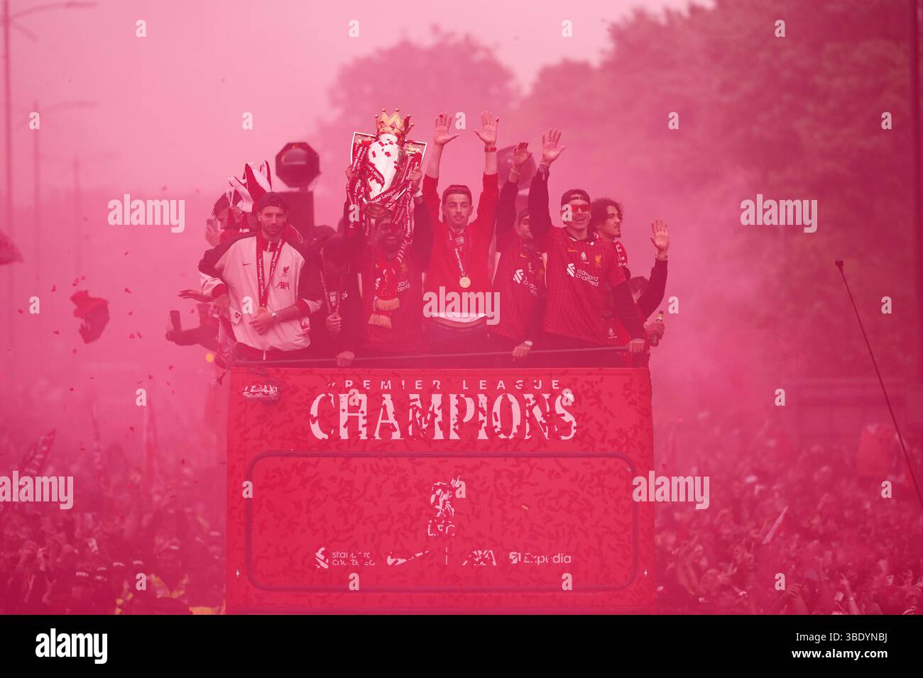 Liverpool players engulfed in red smoke from flares, celebrate with the ...