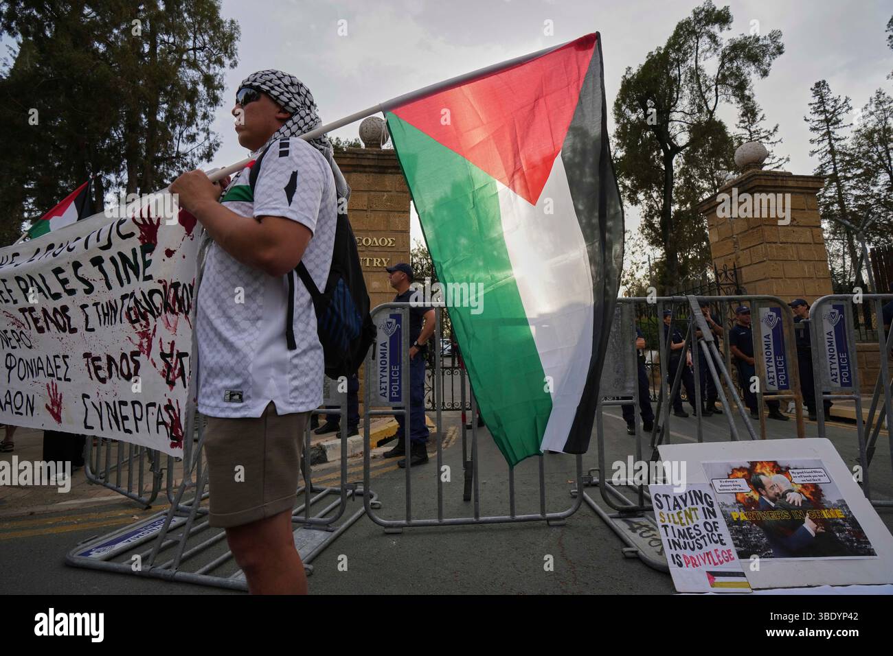 A man holds a Palestinian flag during a protest in Nicosia, Cyprus ...