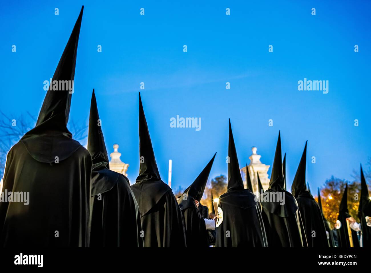 Nazarenes wearing black hoods participate in a solemn procession during ...