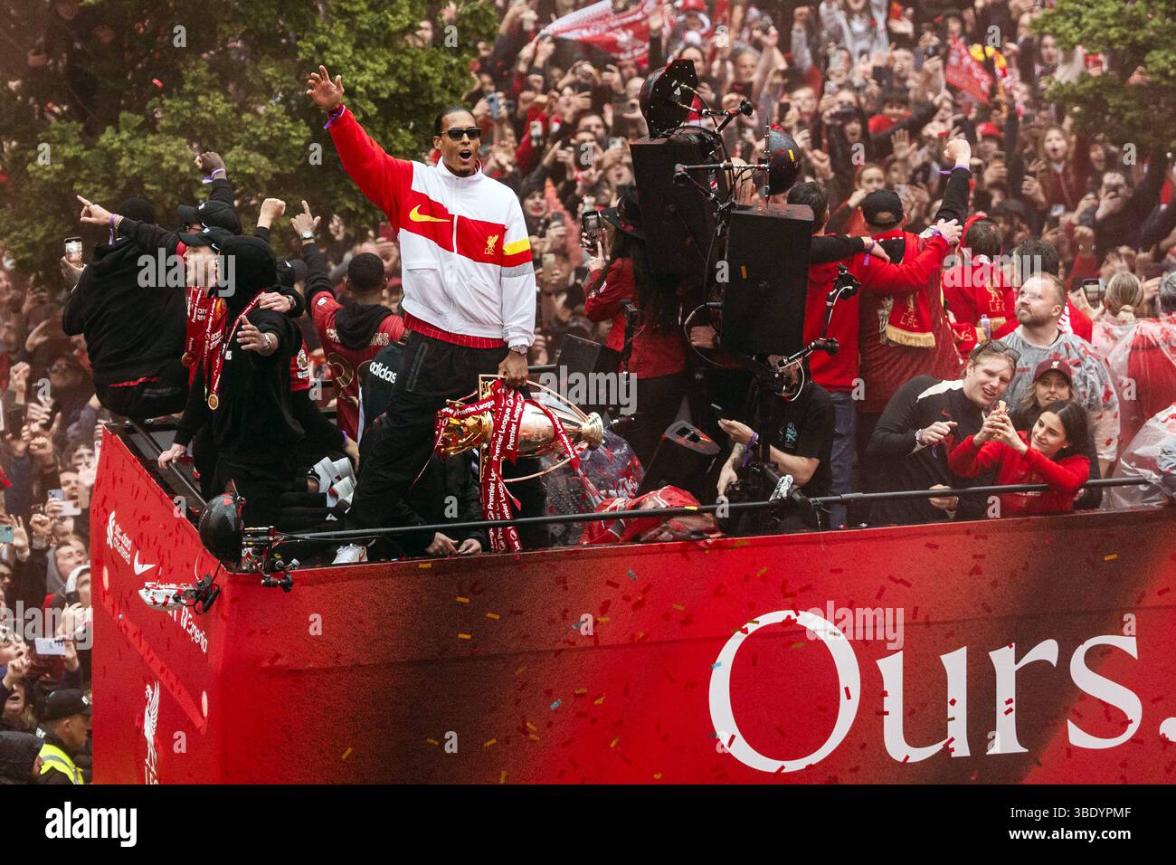 Captain Virgil van Dijk waves from the back of the bus as it makes its ...