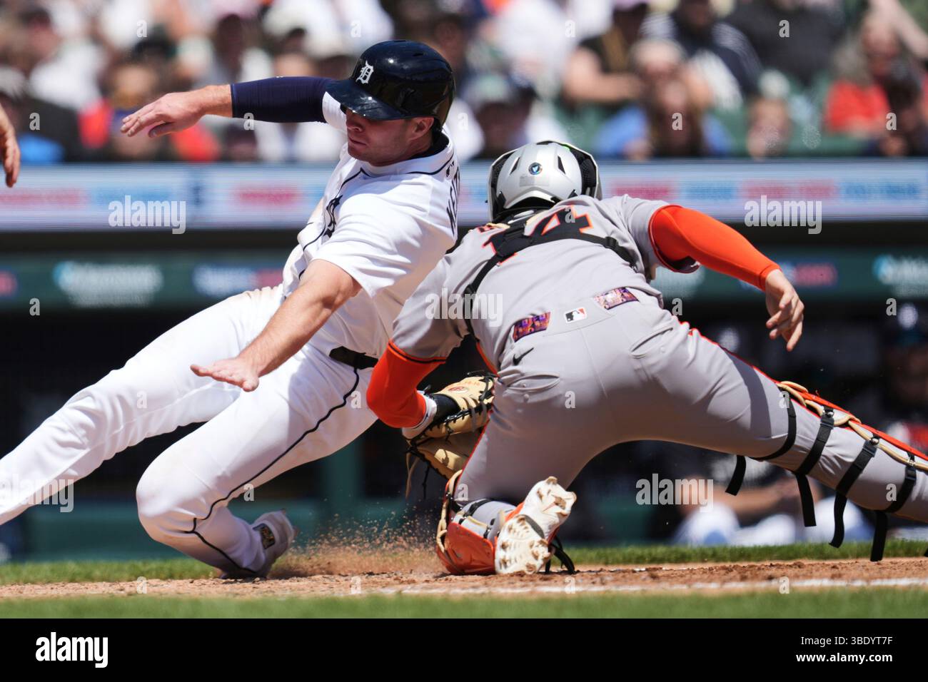 Detroit Tigers second base Colt Keith, left, reaches to score after San ...