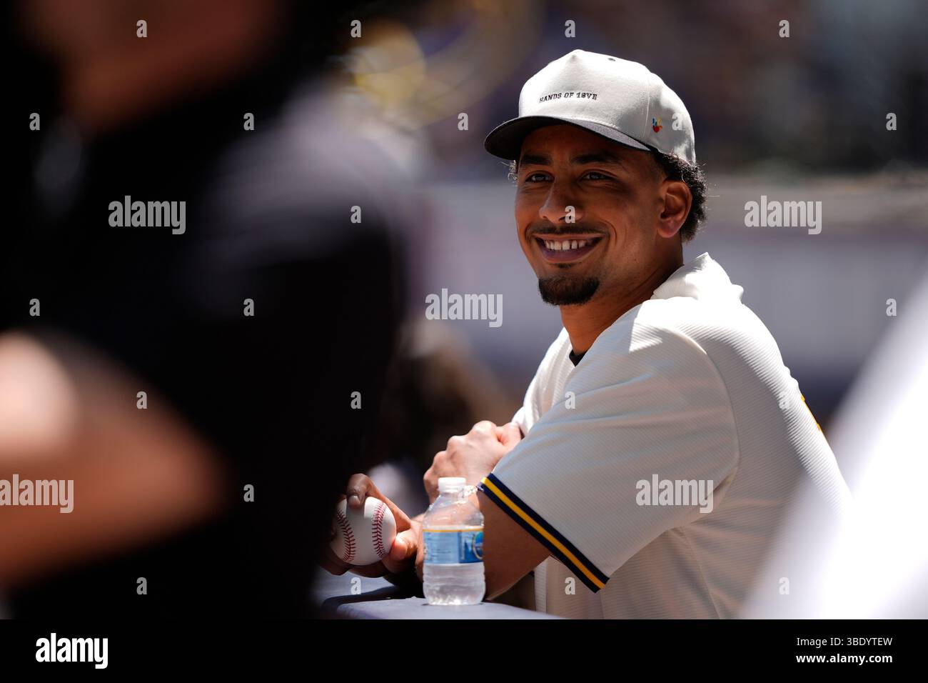 Green Bay Packers' quarterback Jordan Love smiles before a baseball ...