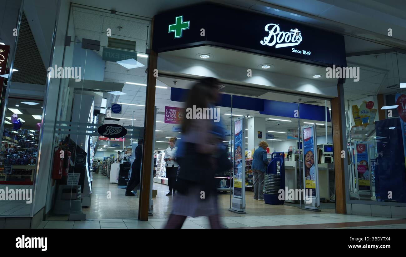 Customers walk past the Boots chemist in the Swan Centre shopping mall ...