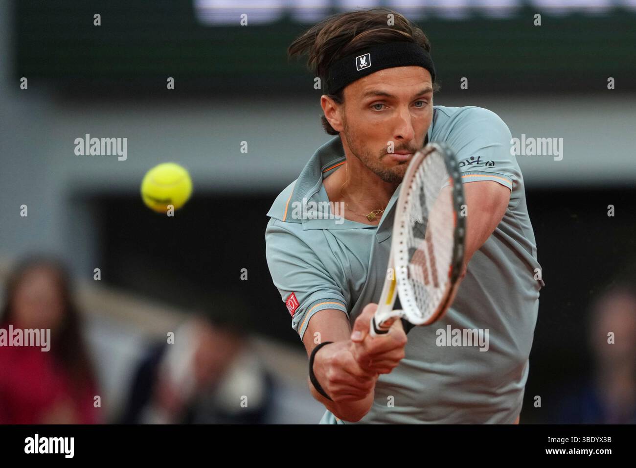 France's Arthur Rinderknech returns the ball to Italy's Jannik Sinner ...