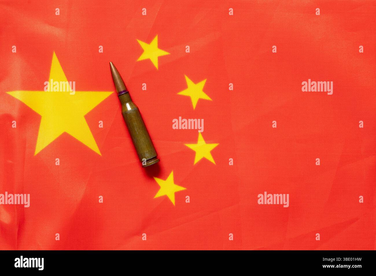 Flag of China with a bullet close-up, symbol of war, weapons and ...