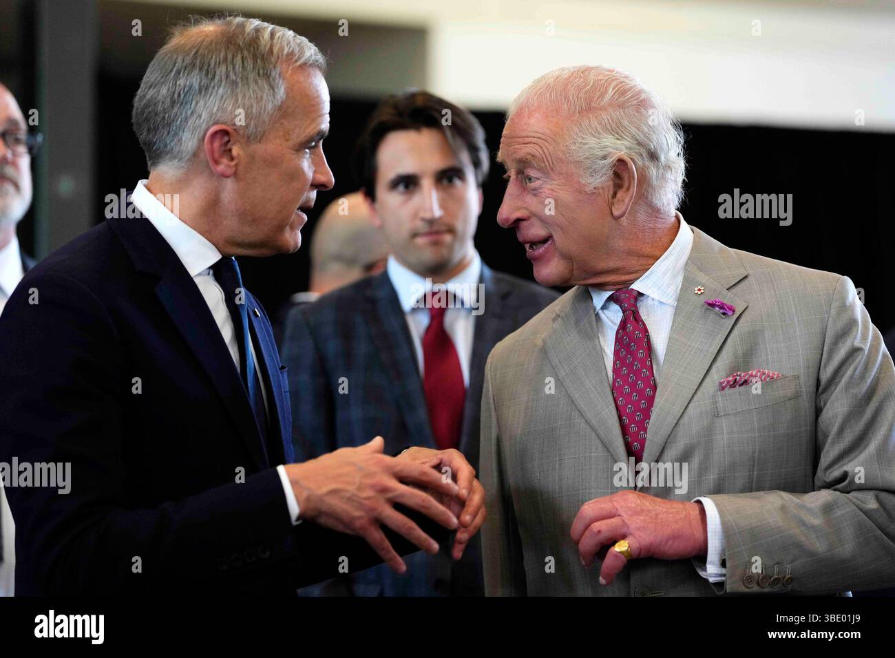King Charles and Prime Minister Mark Carney speak as they view a ...