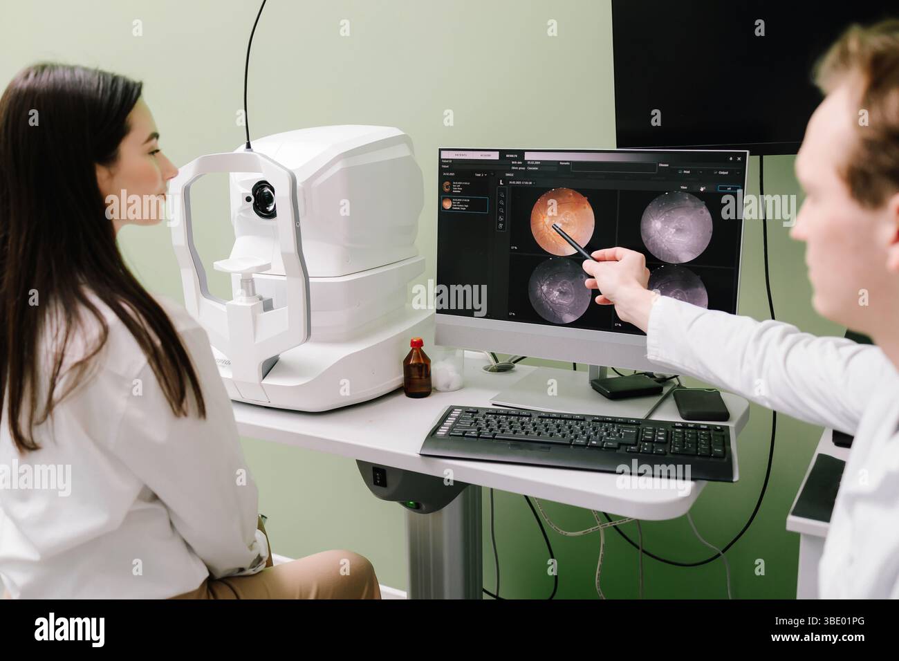 OCT eye scan imaging at an ophthalmology clinic. Girl undergoes a retina exam using optical ...