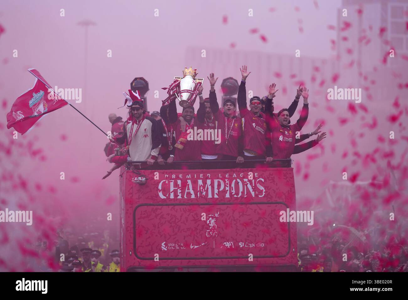 Liverpool players celebrate with the trophy on an open-top bus during ...
