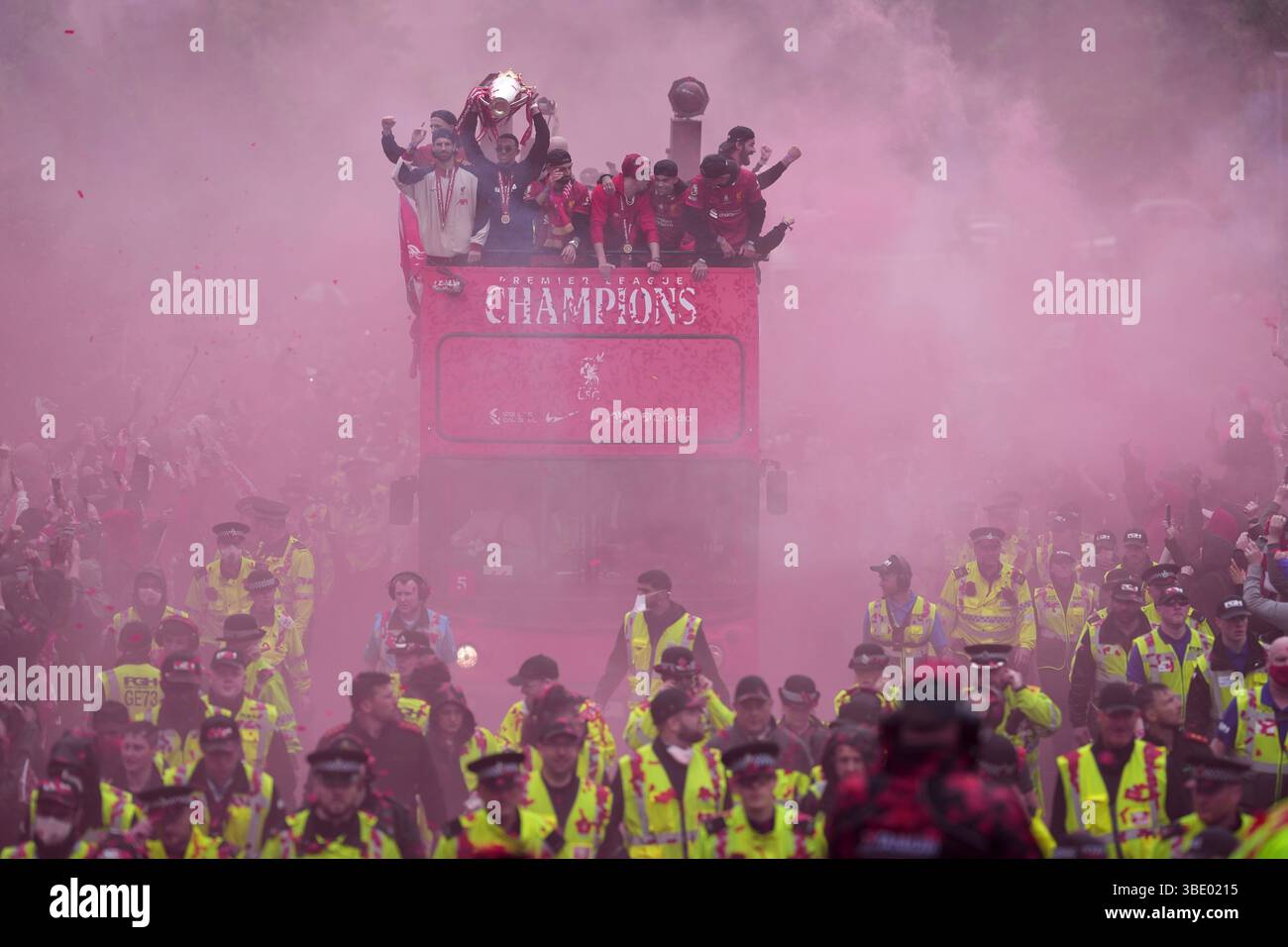Liverpool players celebrate with the trophy on an open-top bus during ...