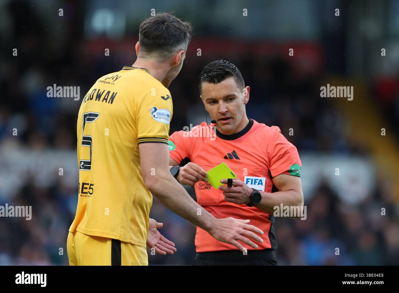 Referee Nick Walsh shows Livingston's Ryan McGowan (left) a yellow card ...