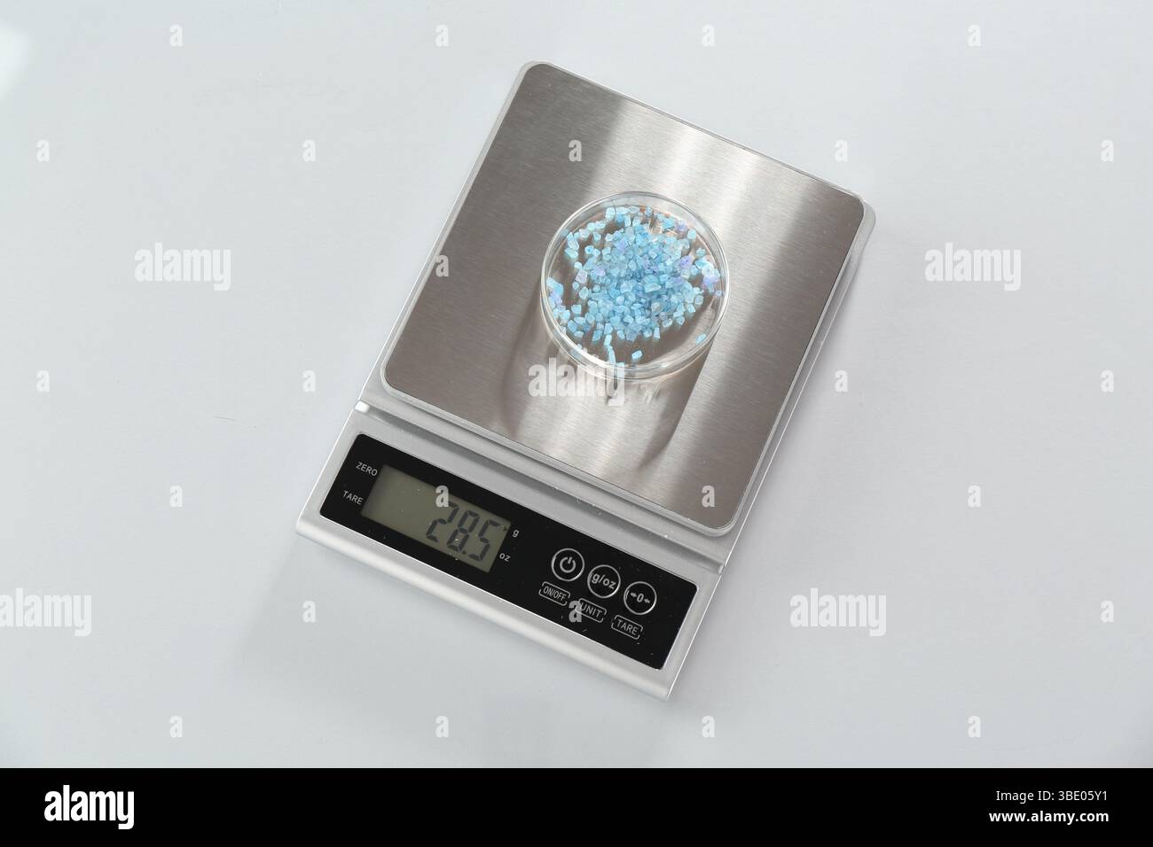 Scale with Petri dish of sample on white table, top view Stock Photo ...