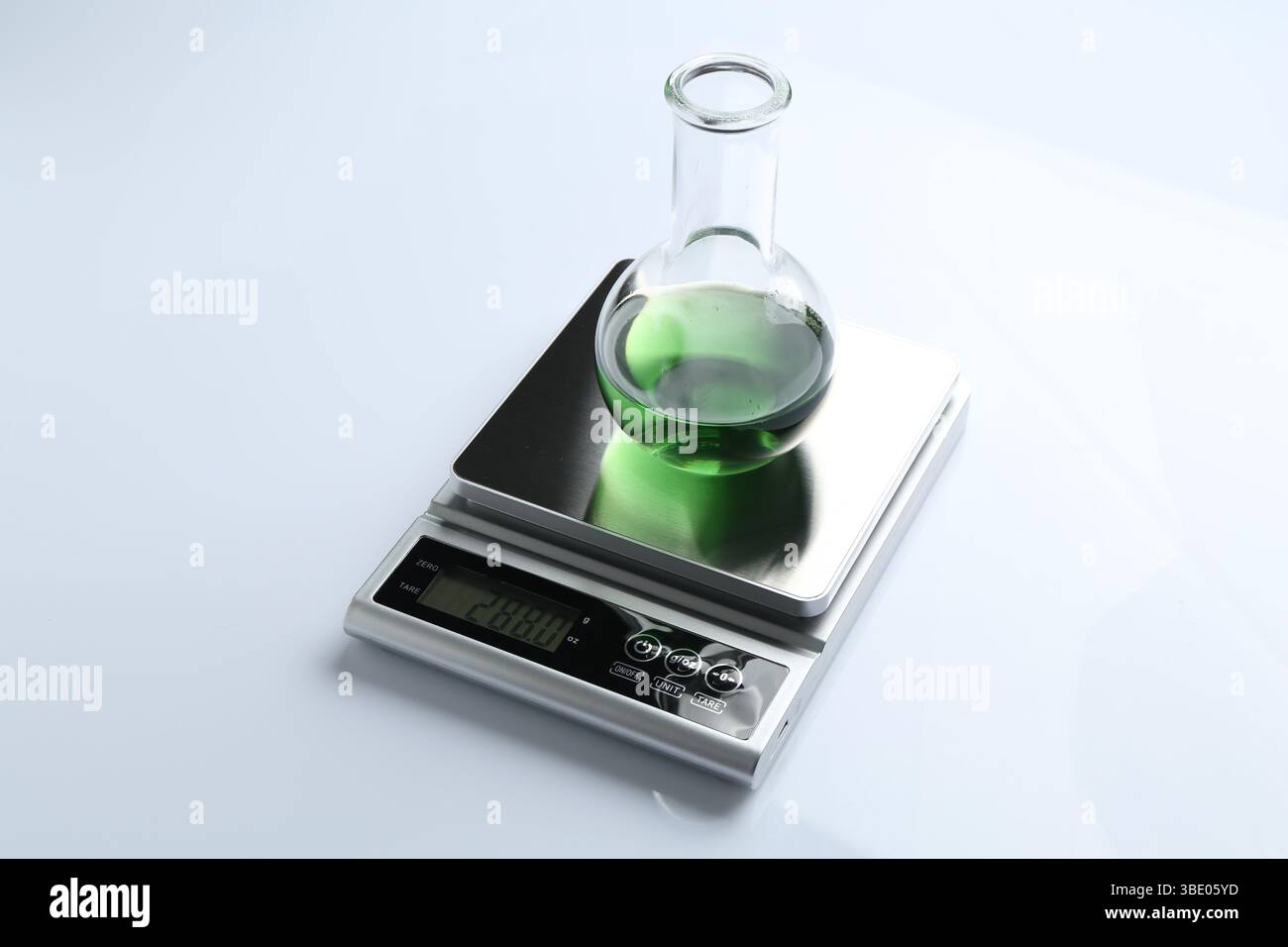Laboratory scale with flask of sample on white background Stock Photo ...