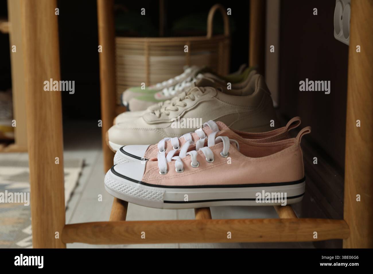 Different footwear on bench indoors. Shoe storage Stock Photo - Alamy
