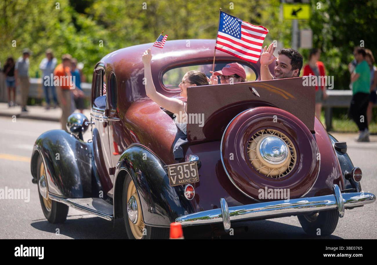 Ellie Ault, left, Katie Ault and Johnny Esposito wave to parade- goers ...
