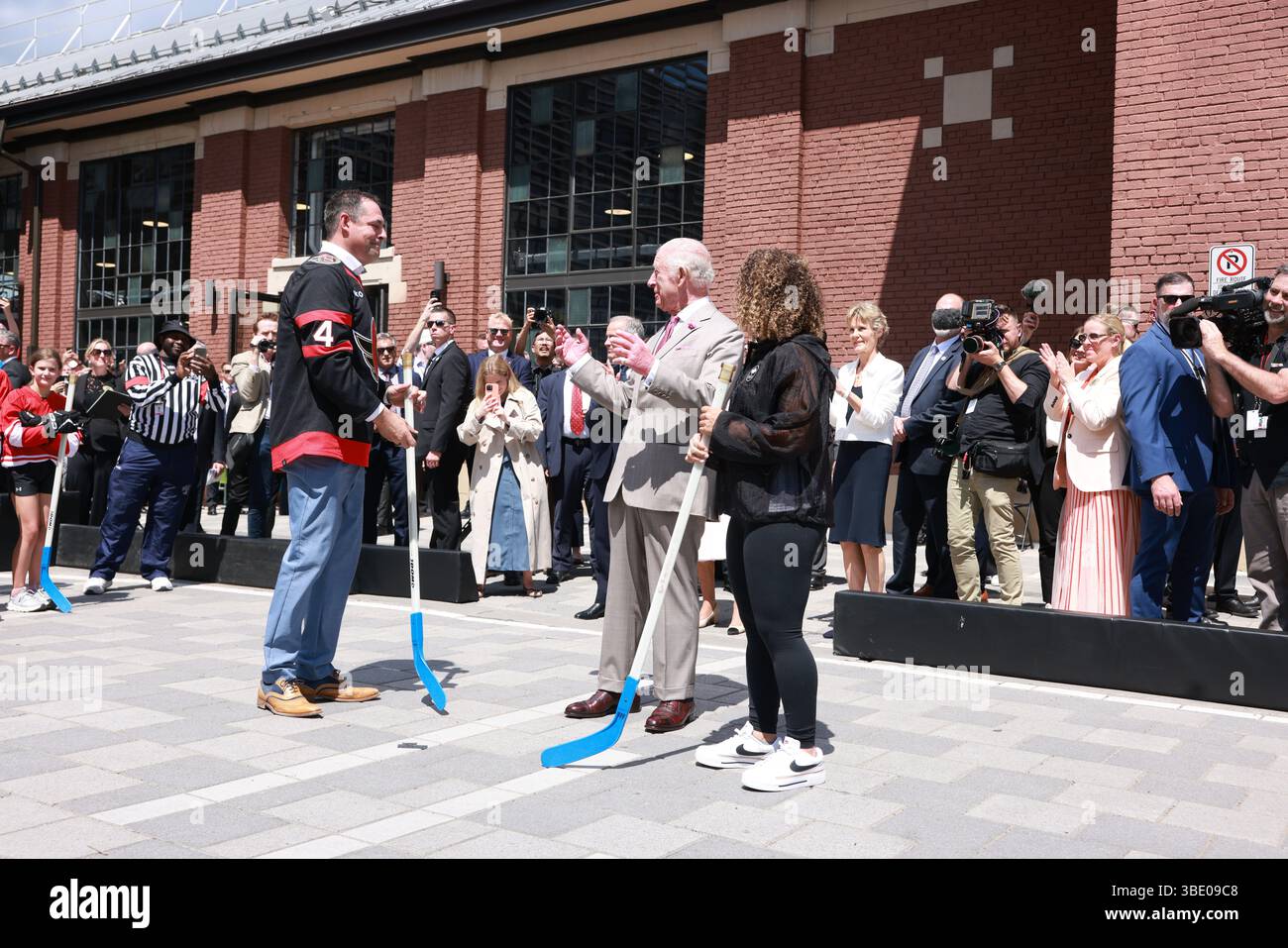 King Charles III puts down the puck for the start of a game of hockey ...