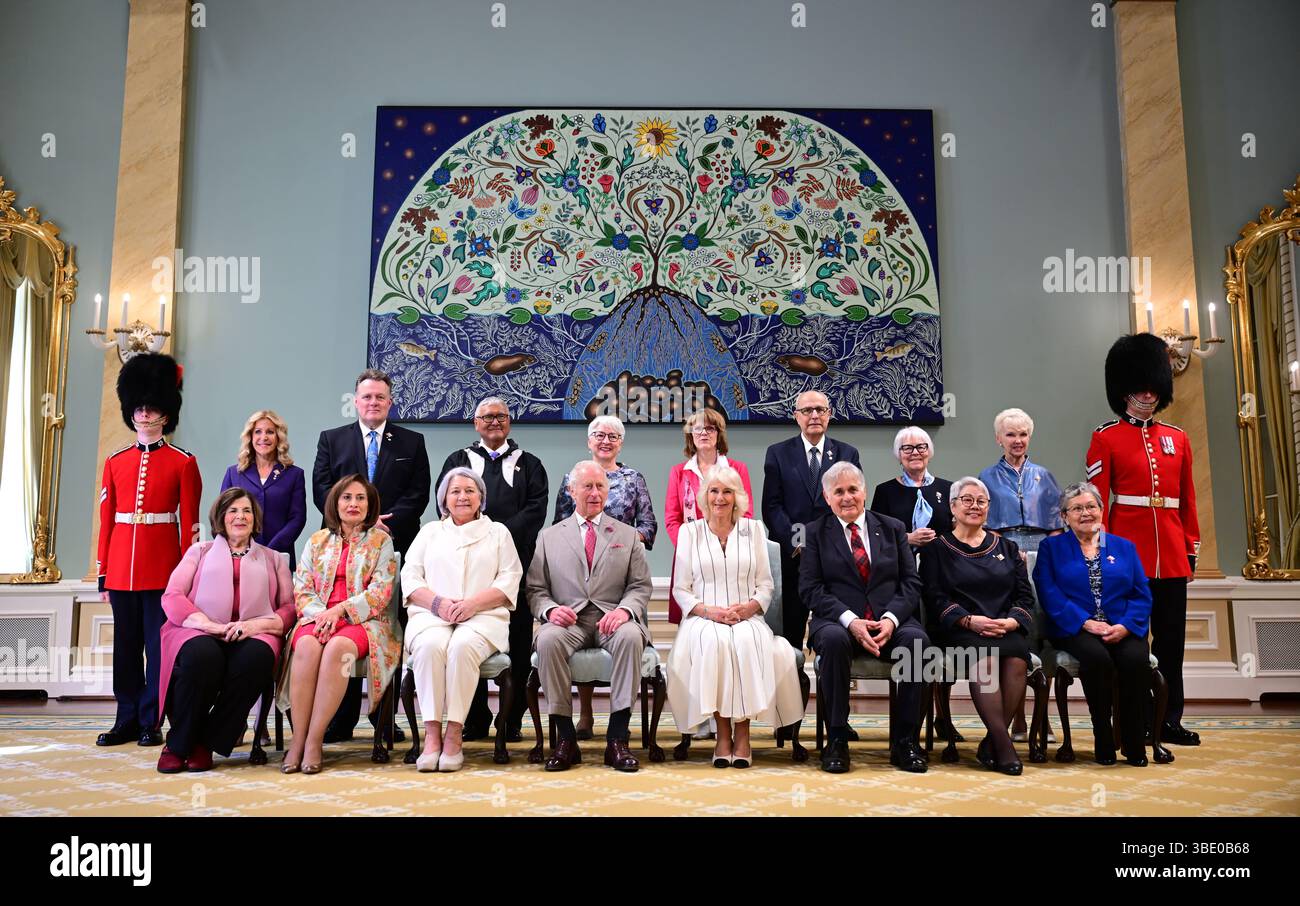 King Charles III and Queen Camilla pose for a photo with the holds an ...