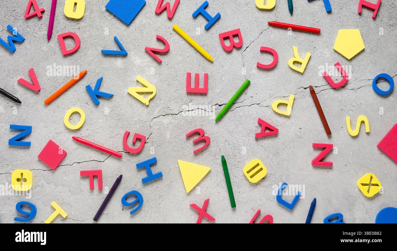 Colorful alphabet letters, numbers, forms, math signs, and crayons ...