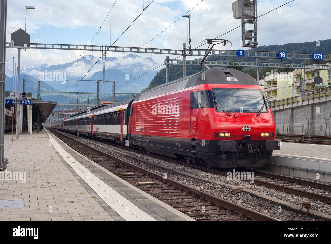 SBB Re 460 electric locomotive 460073 at Spiez railway station (Switzerland) with an intercity ...