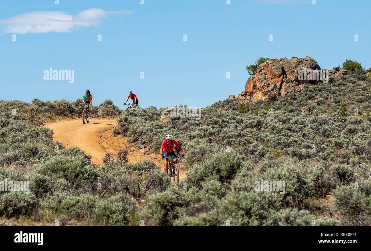 May 25, 2025. Mountain bike cyclists cross through high desert terrain ...
