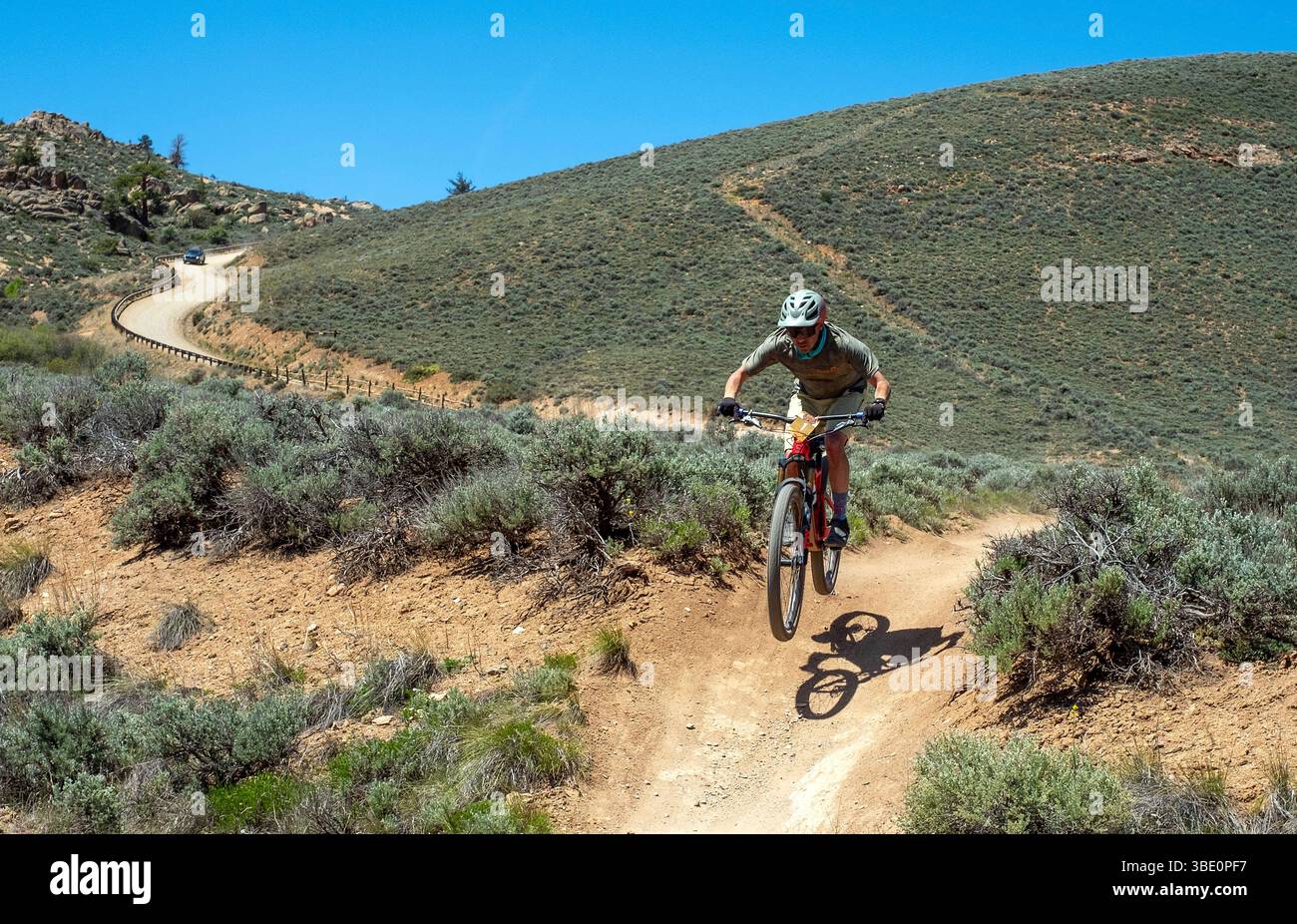May 25, 2025. Mountain bike cyclists cross through high desert terrain ...