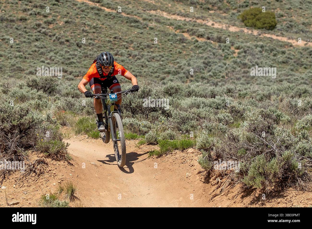 May 25, 2025. Mountain bike cyclists cross through high desert terrain ...