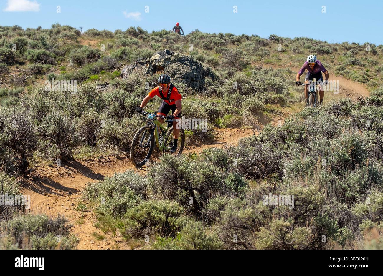 May 25, 2025. Mountain bike cyclists cross through high desert terrain ...