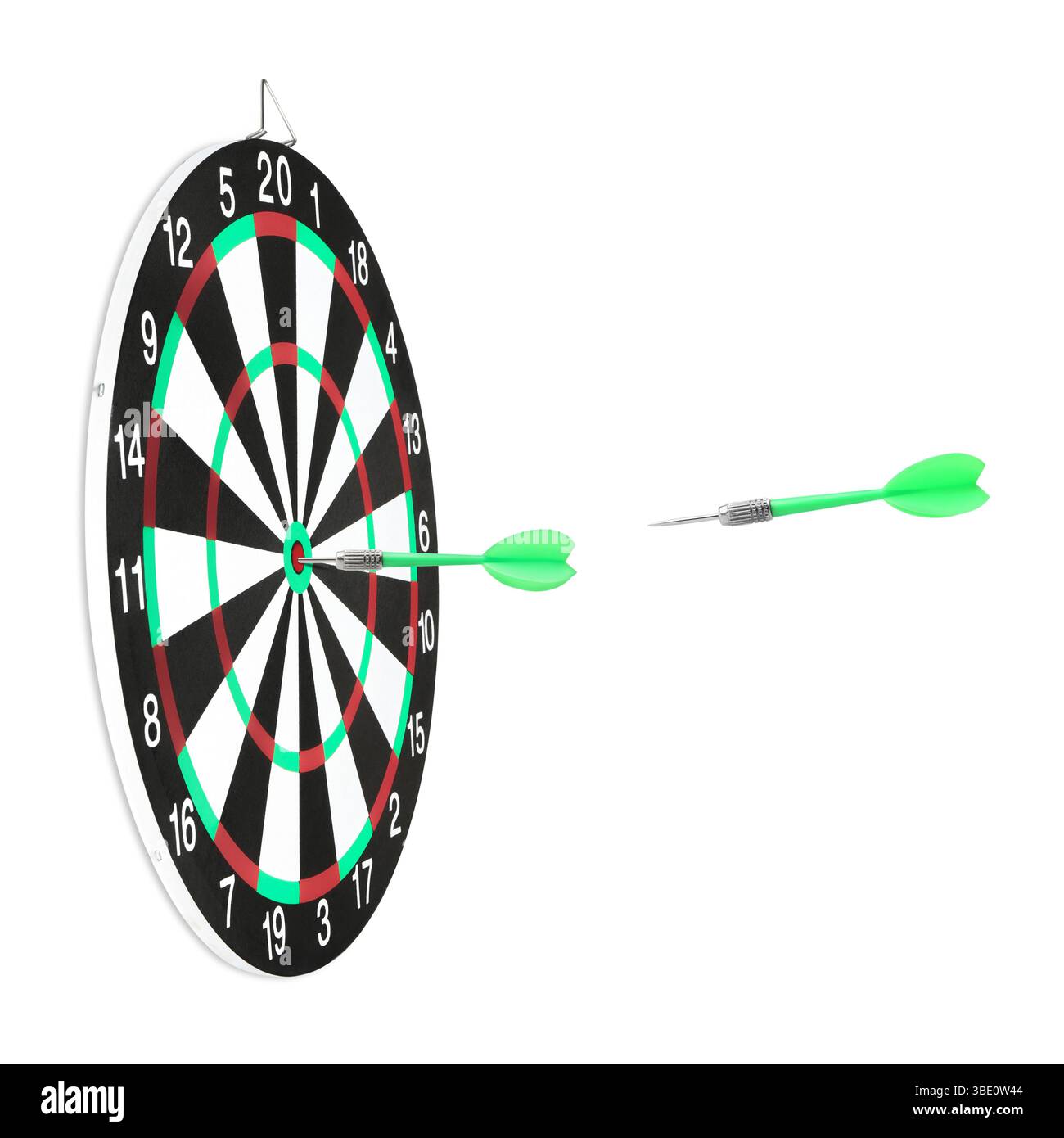 One dart sticking in dartboard and other one flying on white background ...