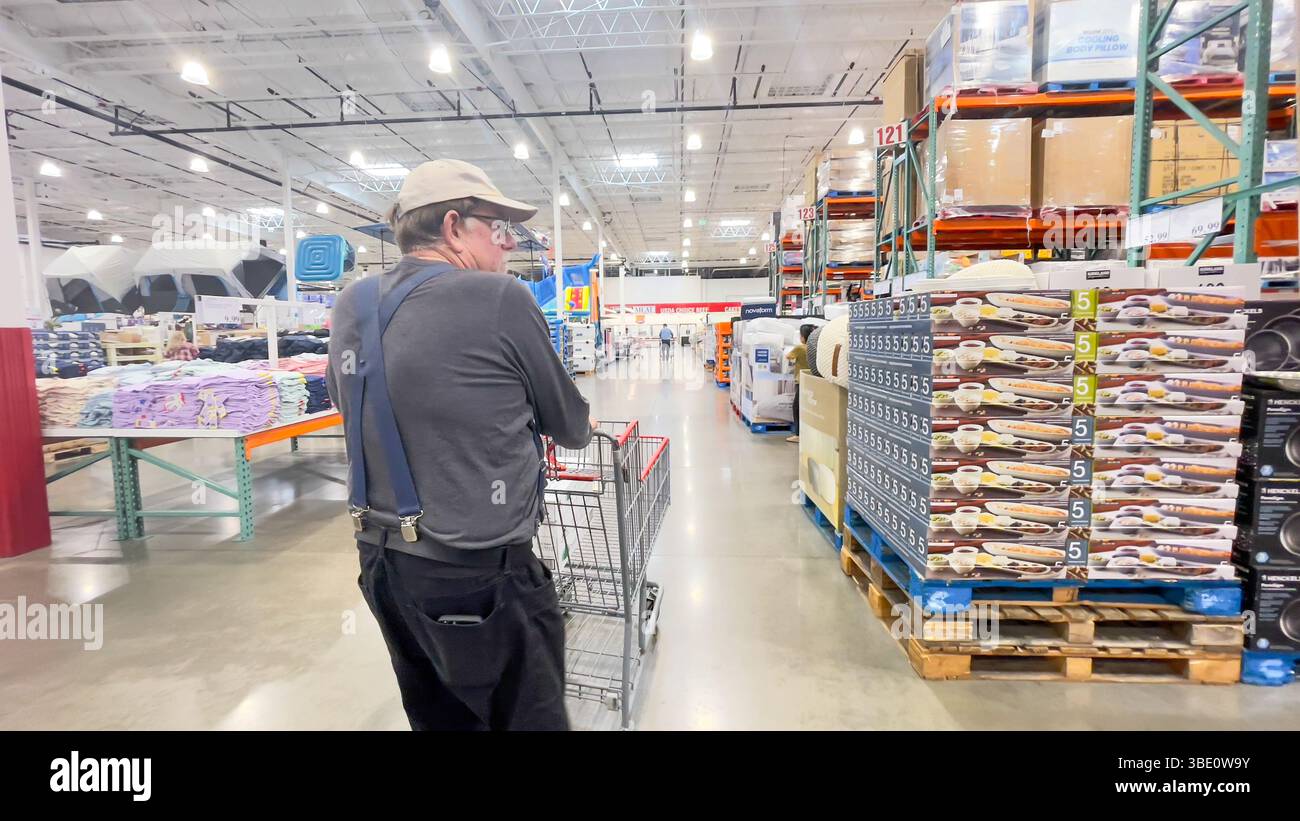 Inside Costco Wholesale Store. A male customer looks at copy paper ...