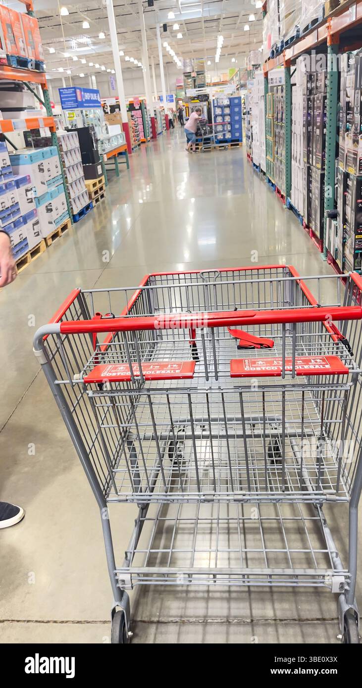 An empty shopping cart in an aisle at Costco. Vertical photo Stock ...
