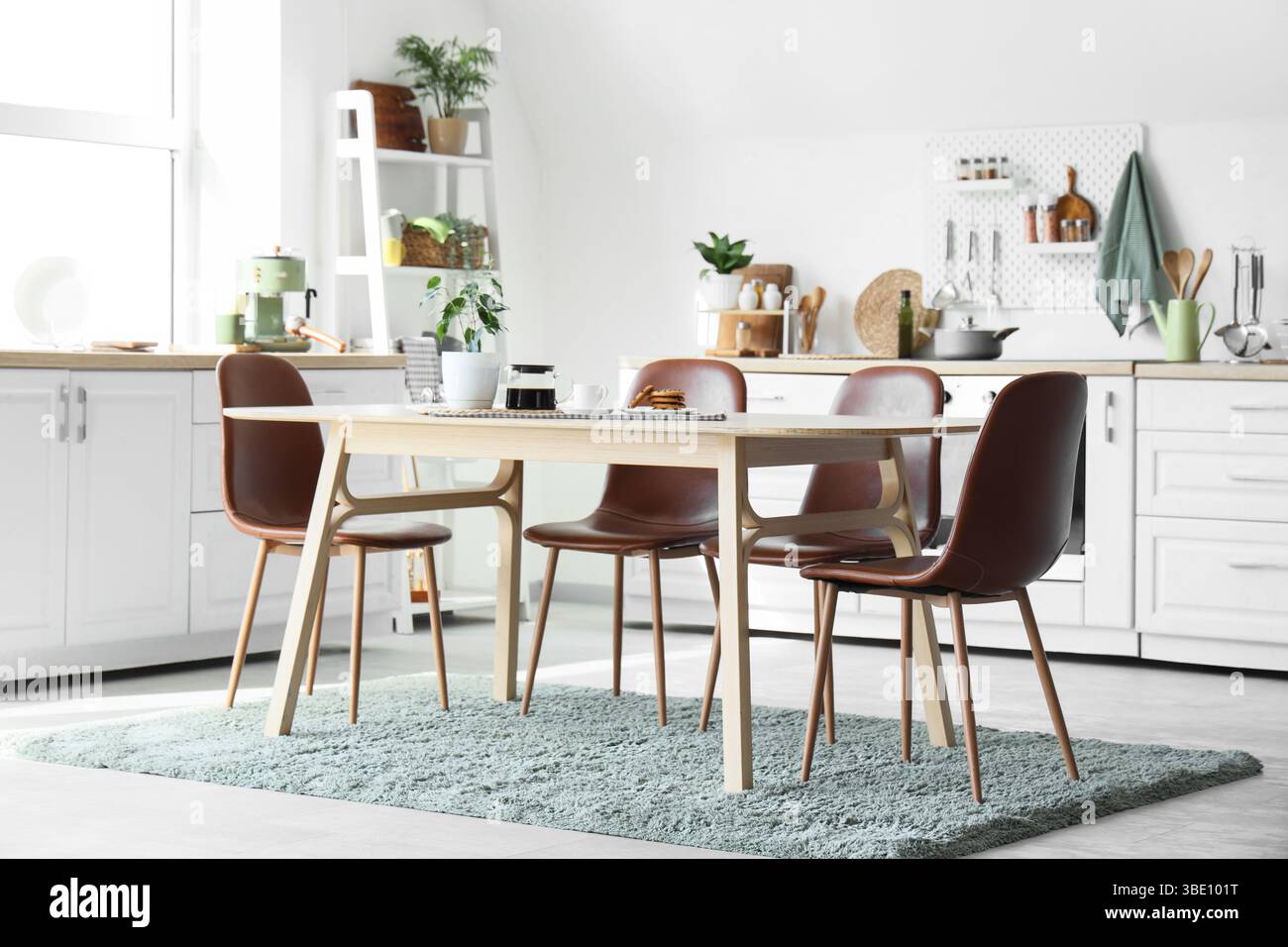 Interior of kitchen with counters, utensils and dining table Stock ...