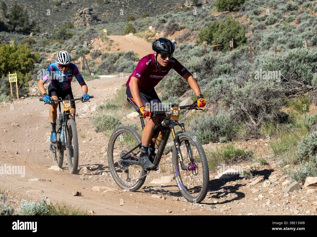 May 25, 2025. Mountain bike cyclists cross through high desert terrain ...