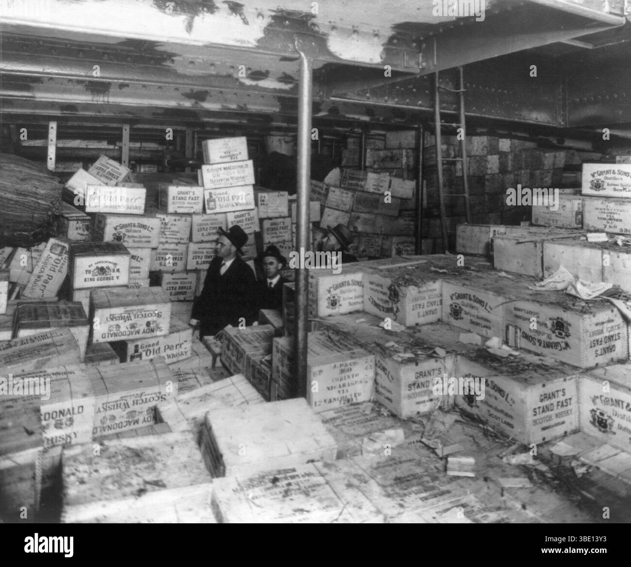 Prohibition agents amid cases of scotch whiskey in hold of ship ...
