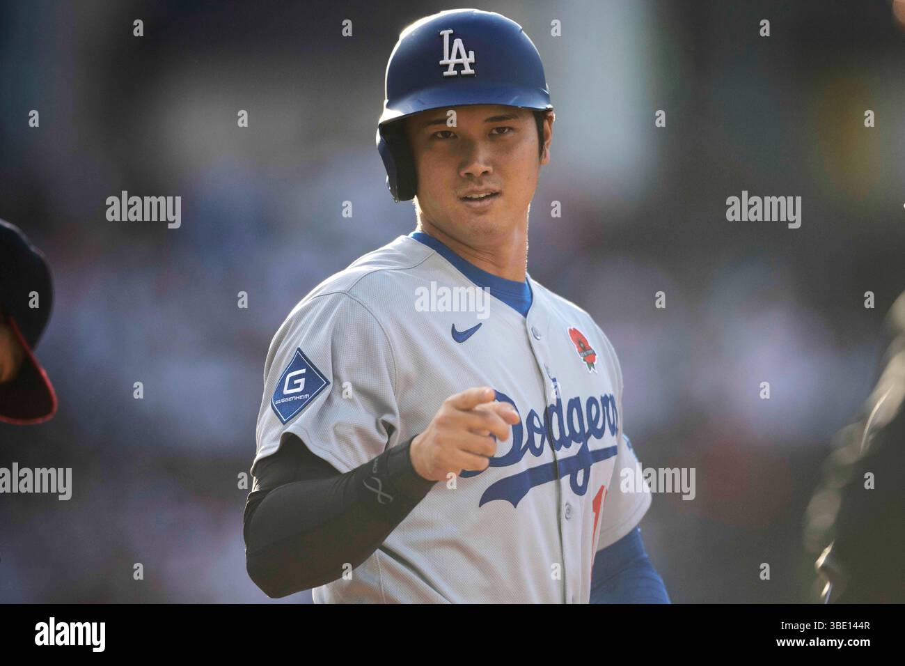Los Angeles Dodgers' Shohei Ohtani points after a walk during the fifth ...