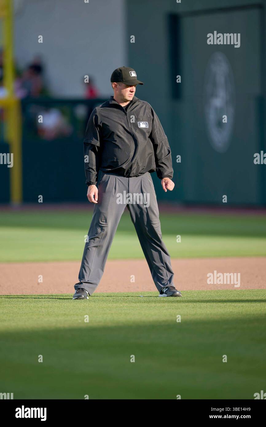 Umpire Tanner Moore handles the calls on the bases during the game ...